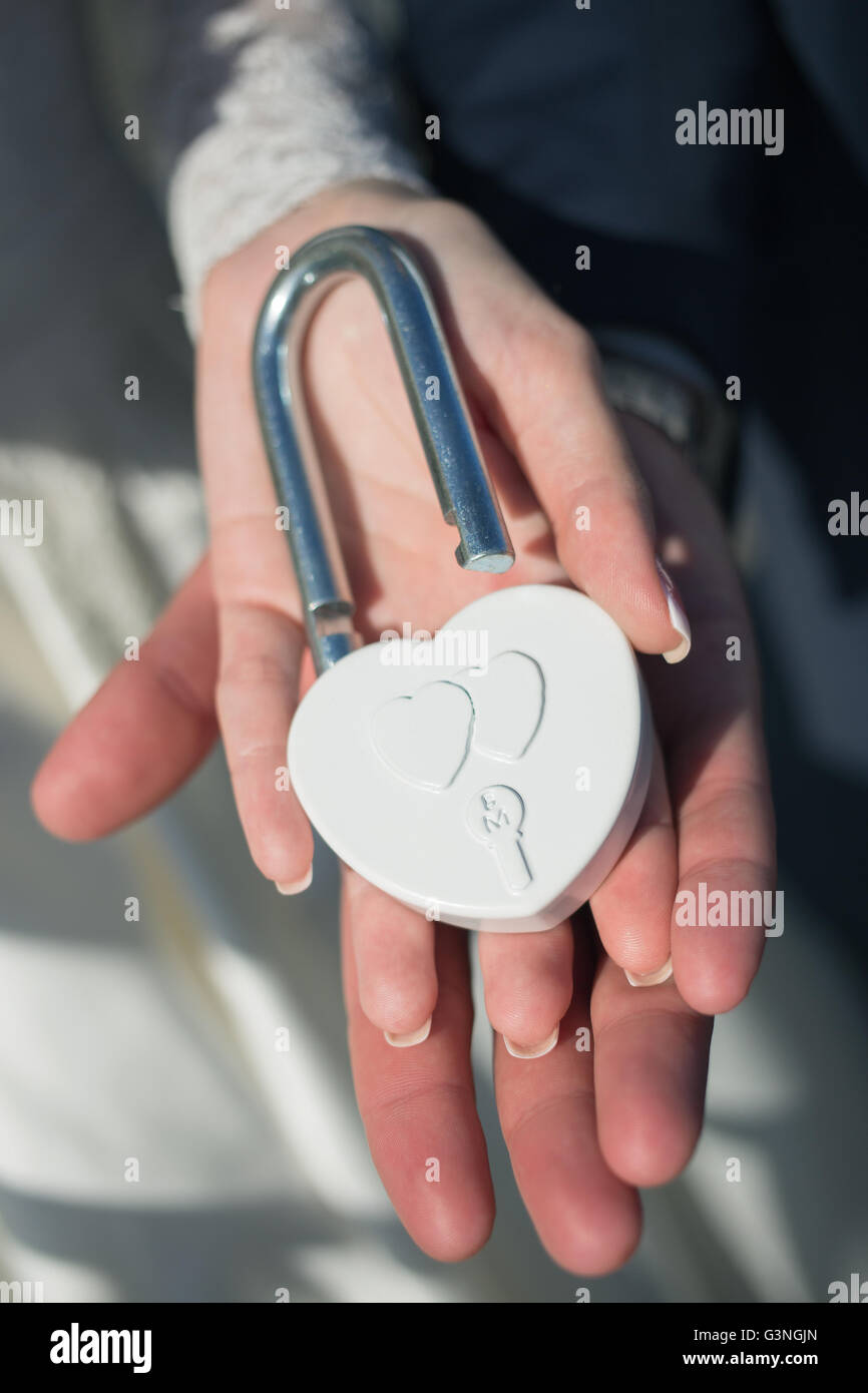 Two hands of lovers with the padlock in the shape of a heart Stock ...