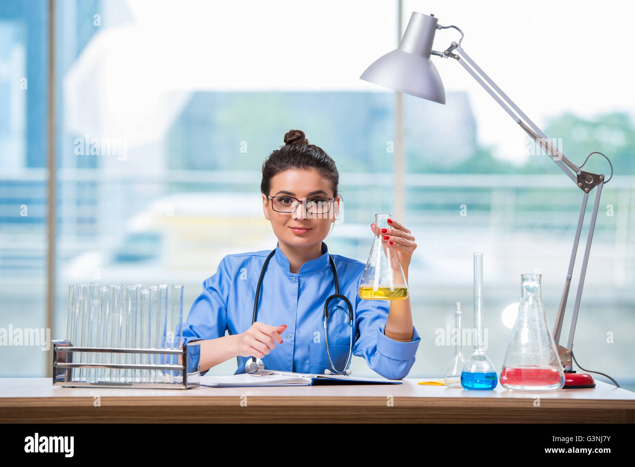 Woman doctor doing chemical tests in laboratory Stock Photo - Alamy