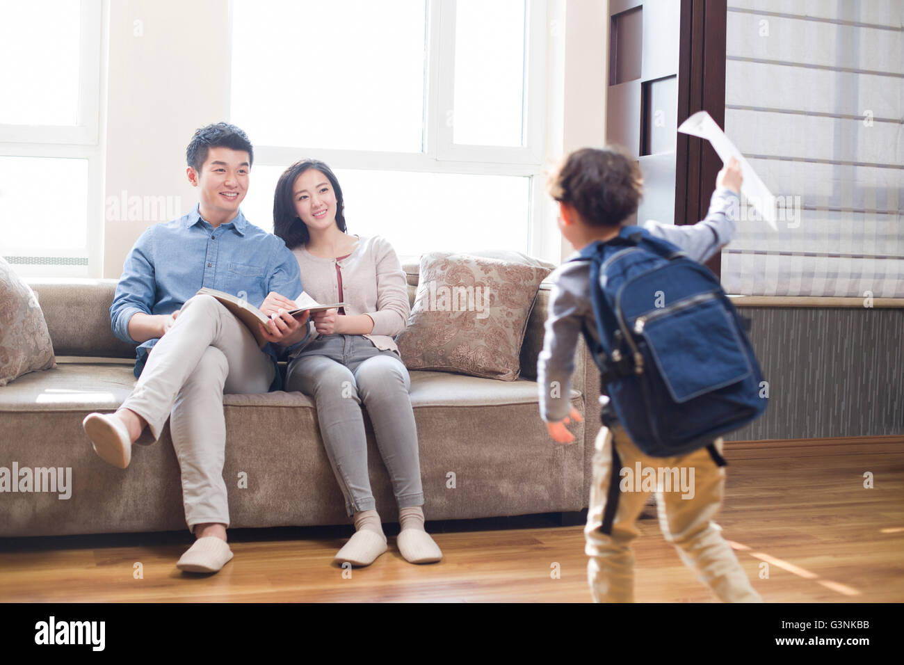 Happy boy coming home from school with a report card Stock Photo - Alamy