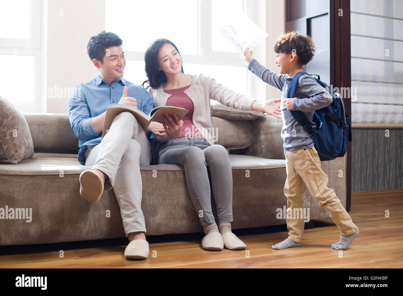 Happy boy coming home from school with a report card Stock Photo - Alamy