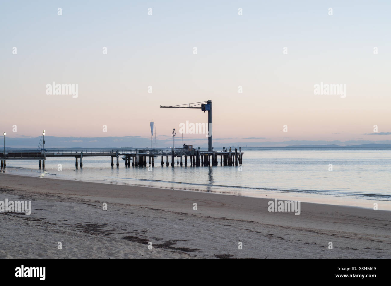 Docking station for boats next to the beach shore during a light sunset ...