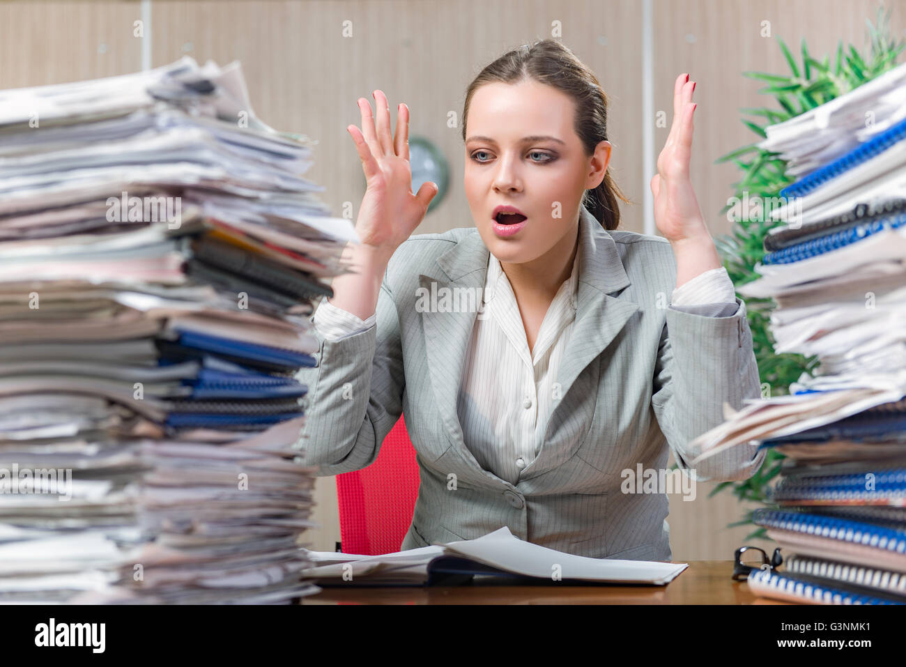 Woman under stress from excessive paper work Stock Photo - Alamy