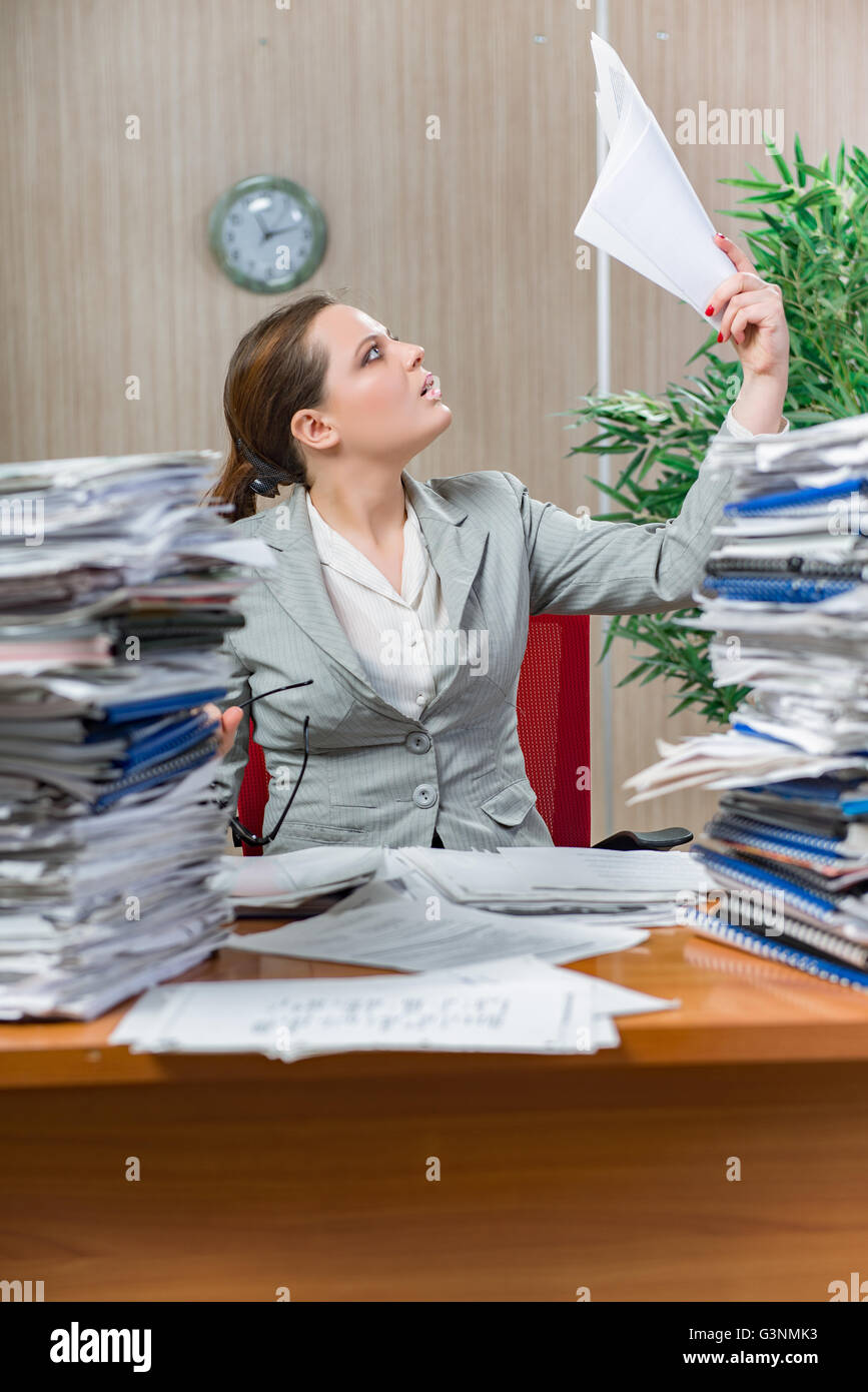 Woman under stress from excessive paper work Stock Photo - Alamy