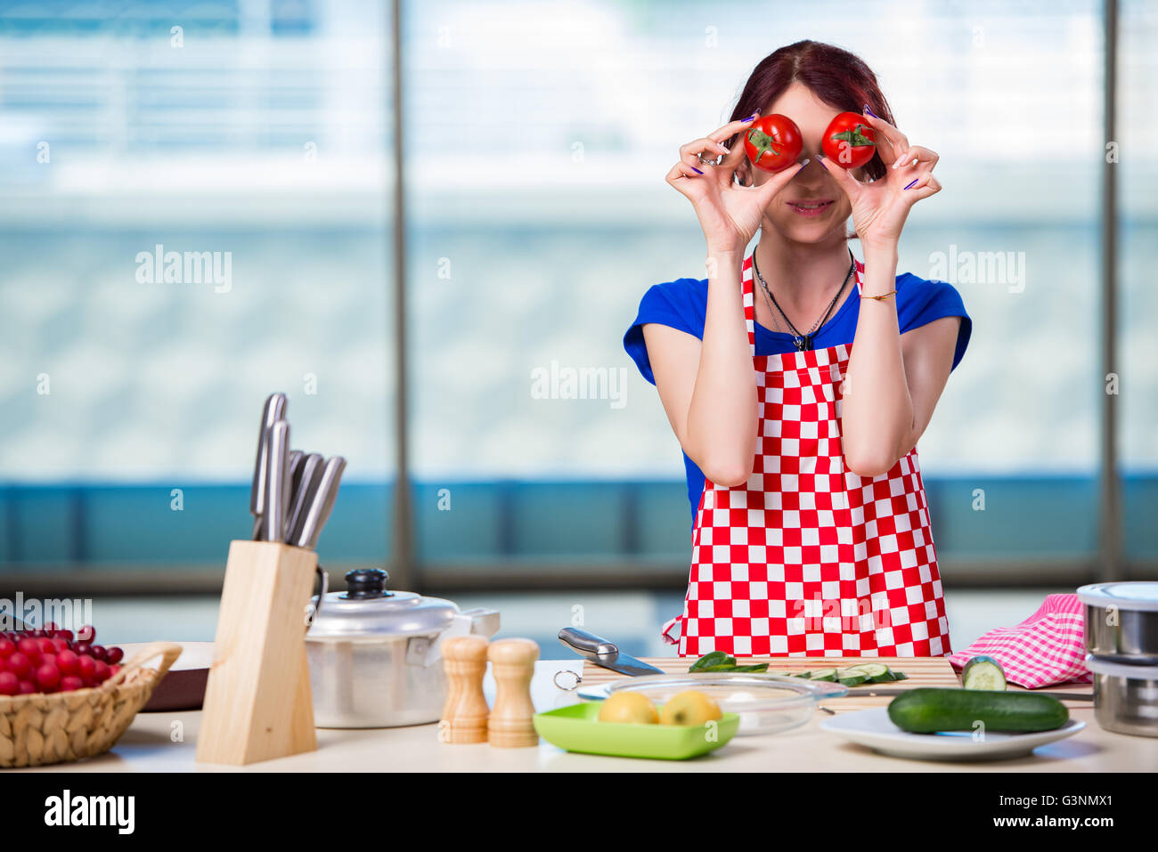 Young woman working in the kitchen Stock Photo - Alamy