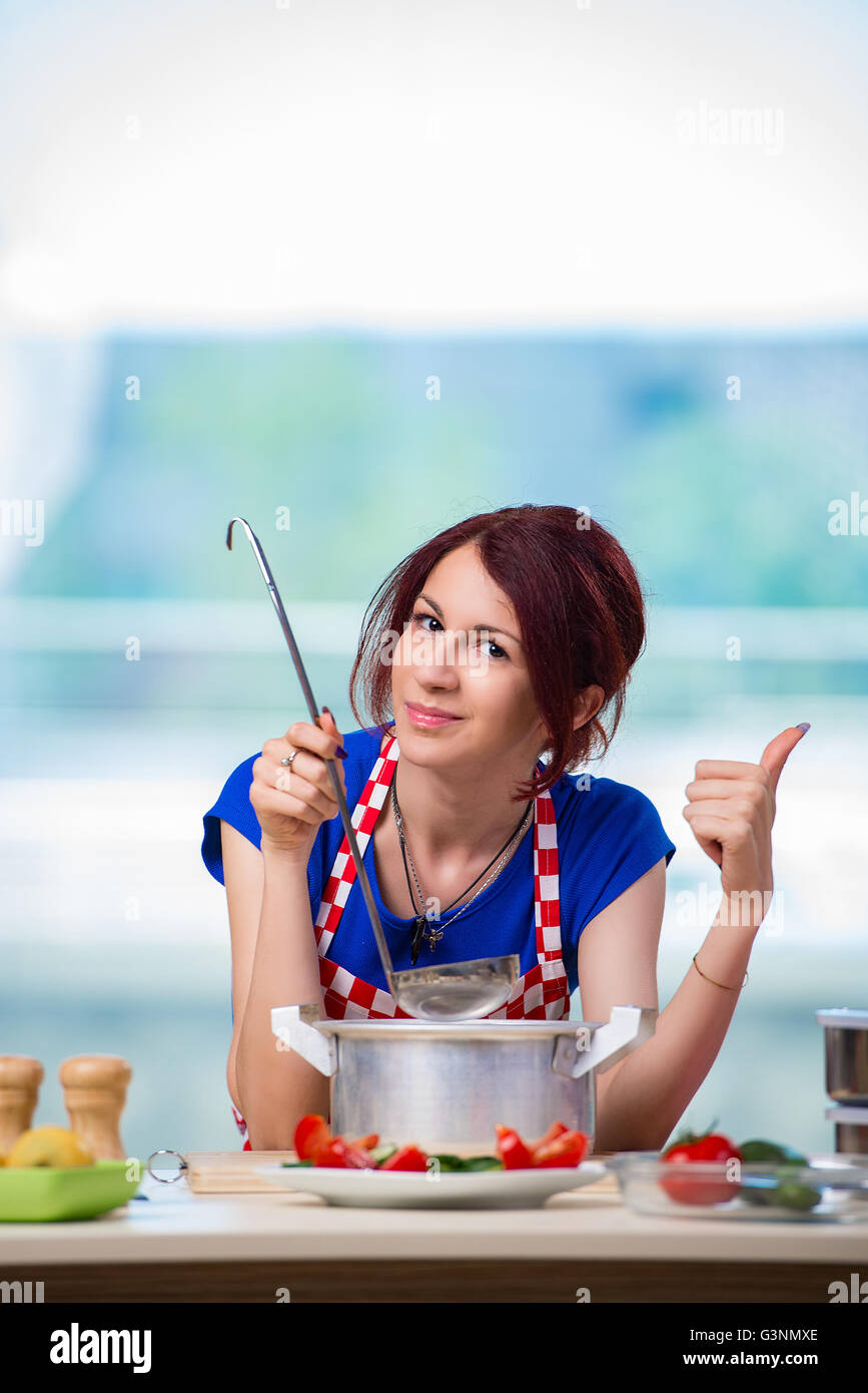 Woman preparing soup in the kitchen Stock Photo - Alamy