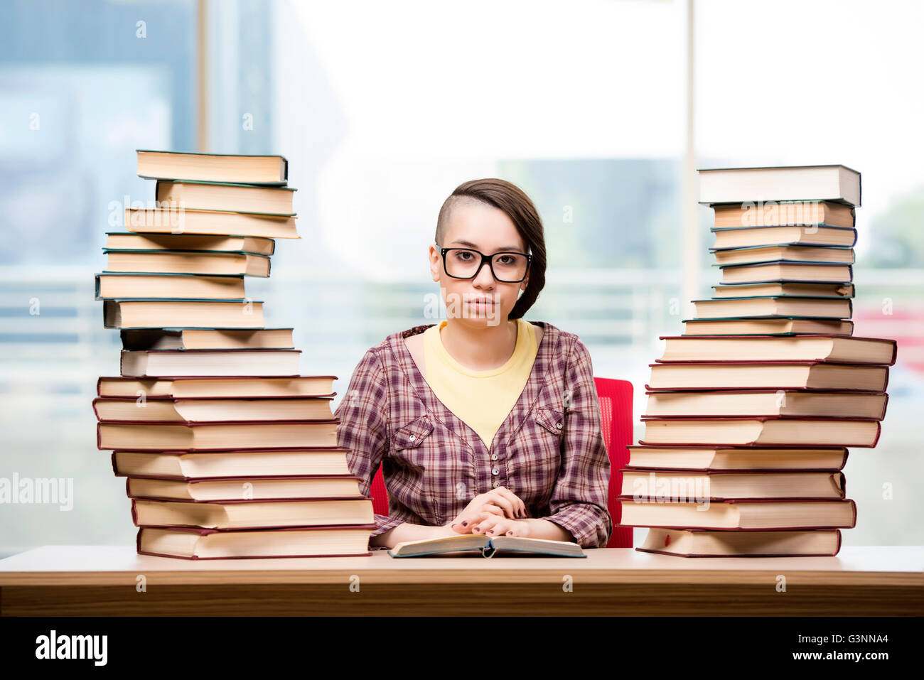 Young student with stack of books Stock Photo - Alamy