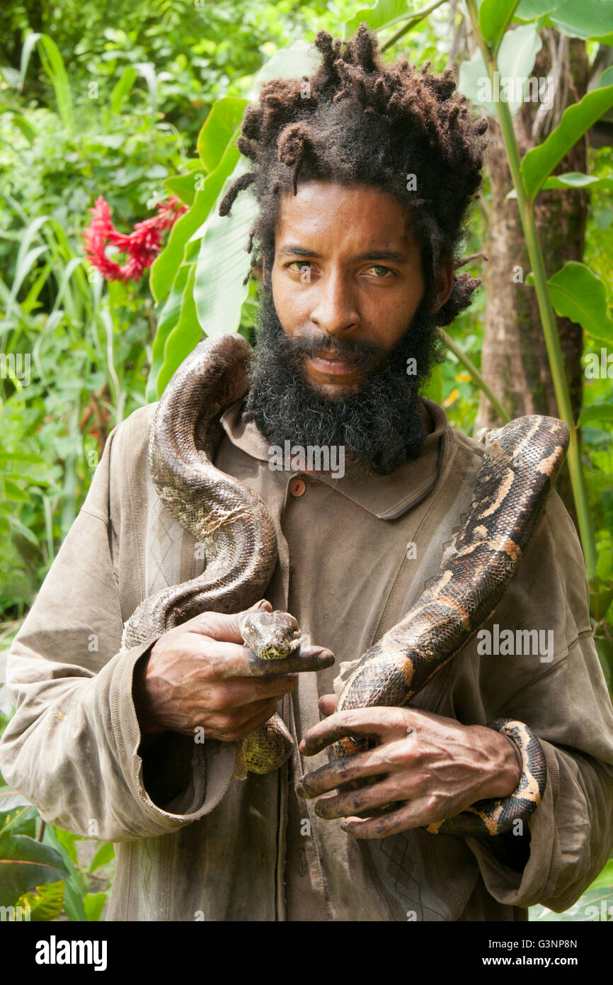 Man in dreadlocks holding his pet Boa Constrictor snake, Wotten Waven ...