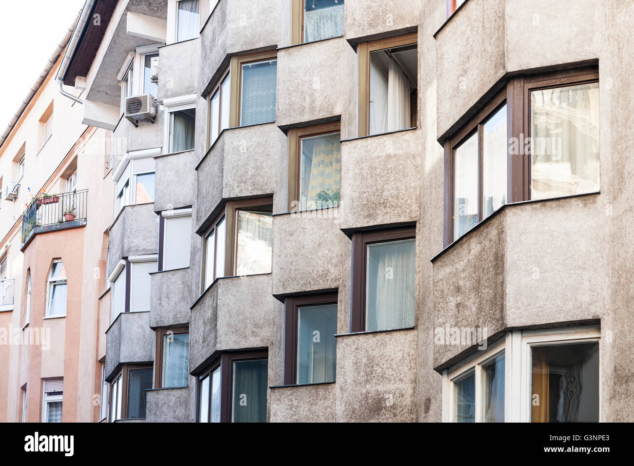 Monochromatic exterior of an apartment building with windows forming a ...