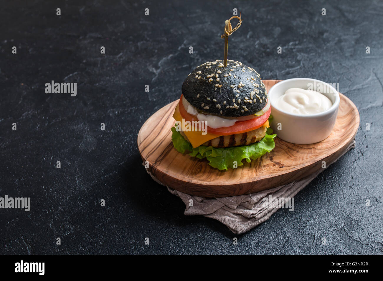 black burger with grilled chicken patty Stock Photo - Alamy