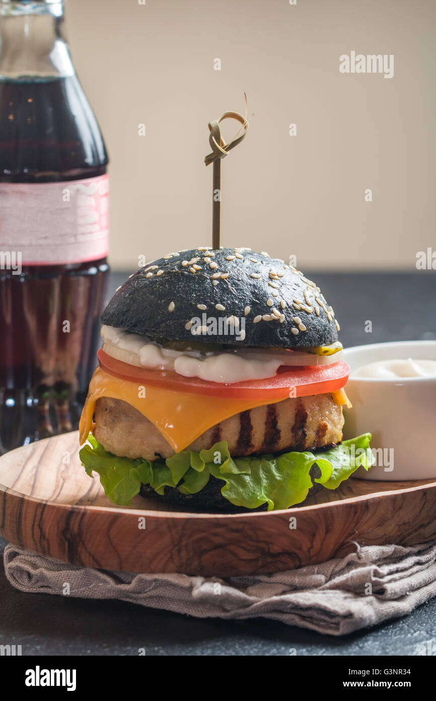 black burger with grilled chicken patty Stock Photo - Alamy