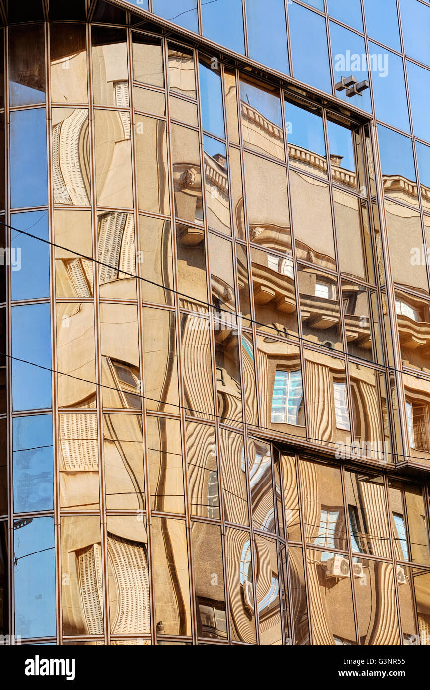 reflection of stone facade on modern glass facade Stock Photo - Alamy