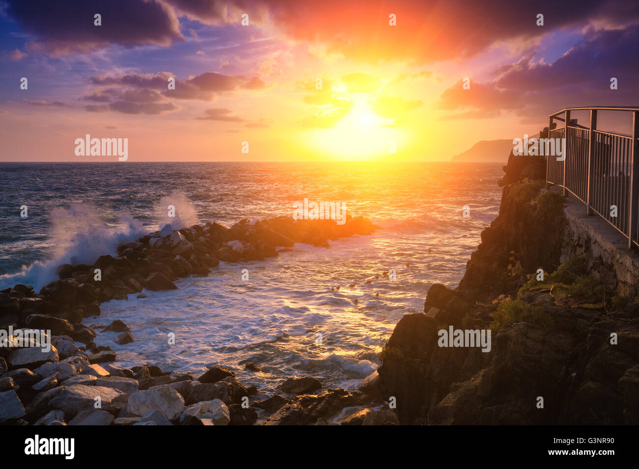 Sunset over rocky sea coast Stock Photo - Alamy