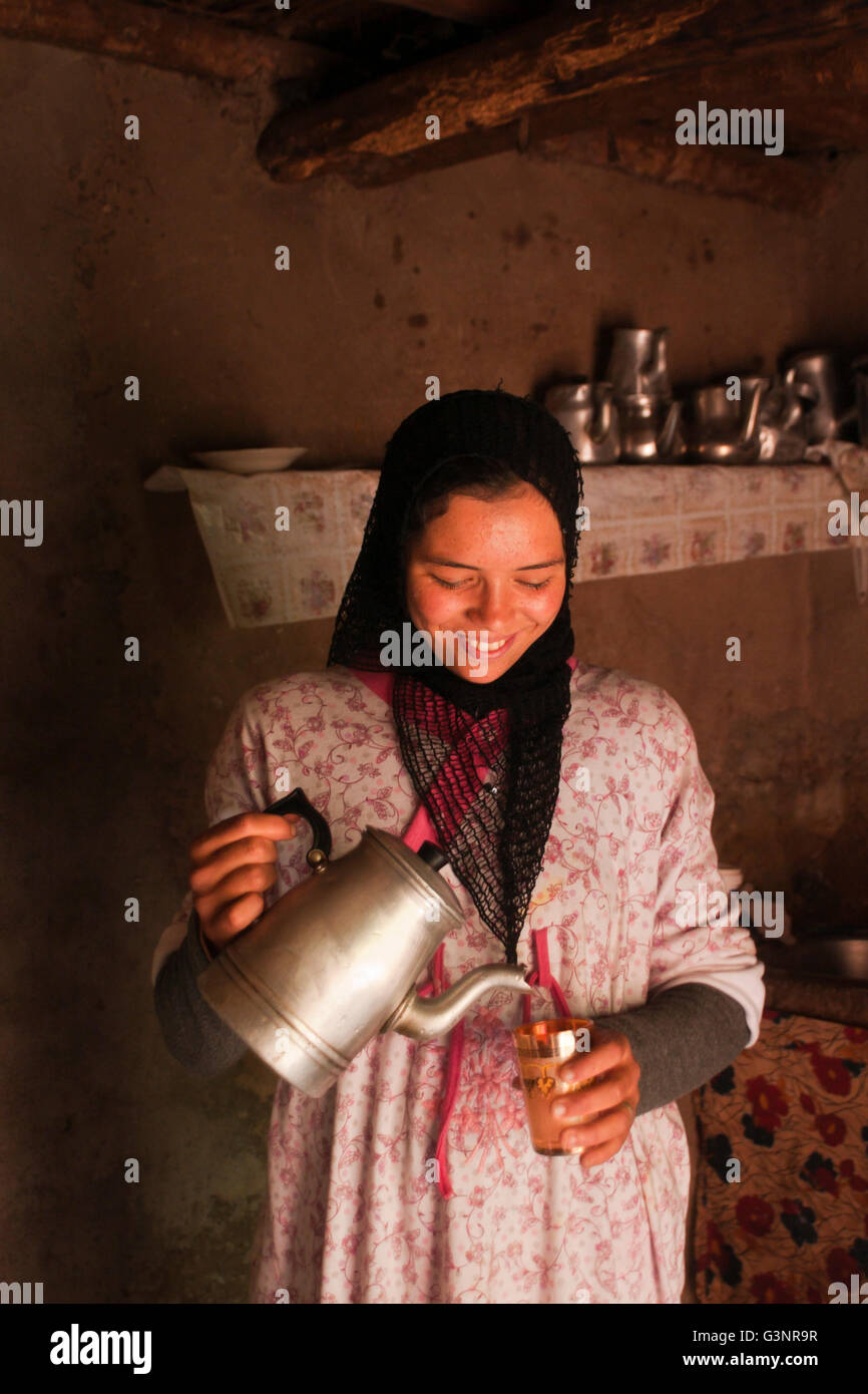 Berber teenaged girl pouring mint tea; Ait Souka Village, High Atlas ...