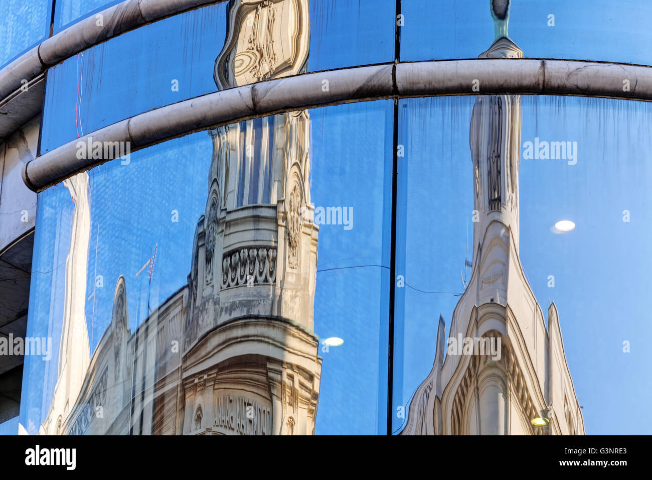 reflection of stone facade on modern glass facade Stock Photo - Alamy