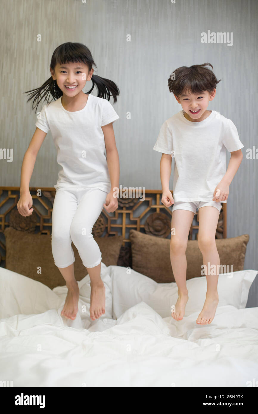 Children jumping on bed hi-res stock photography and images - Alamy