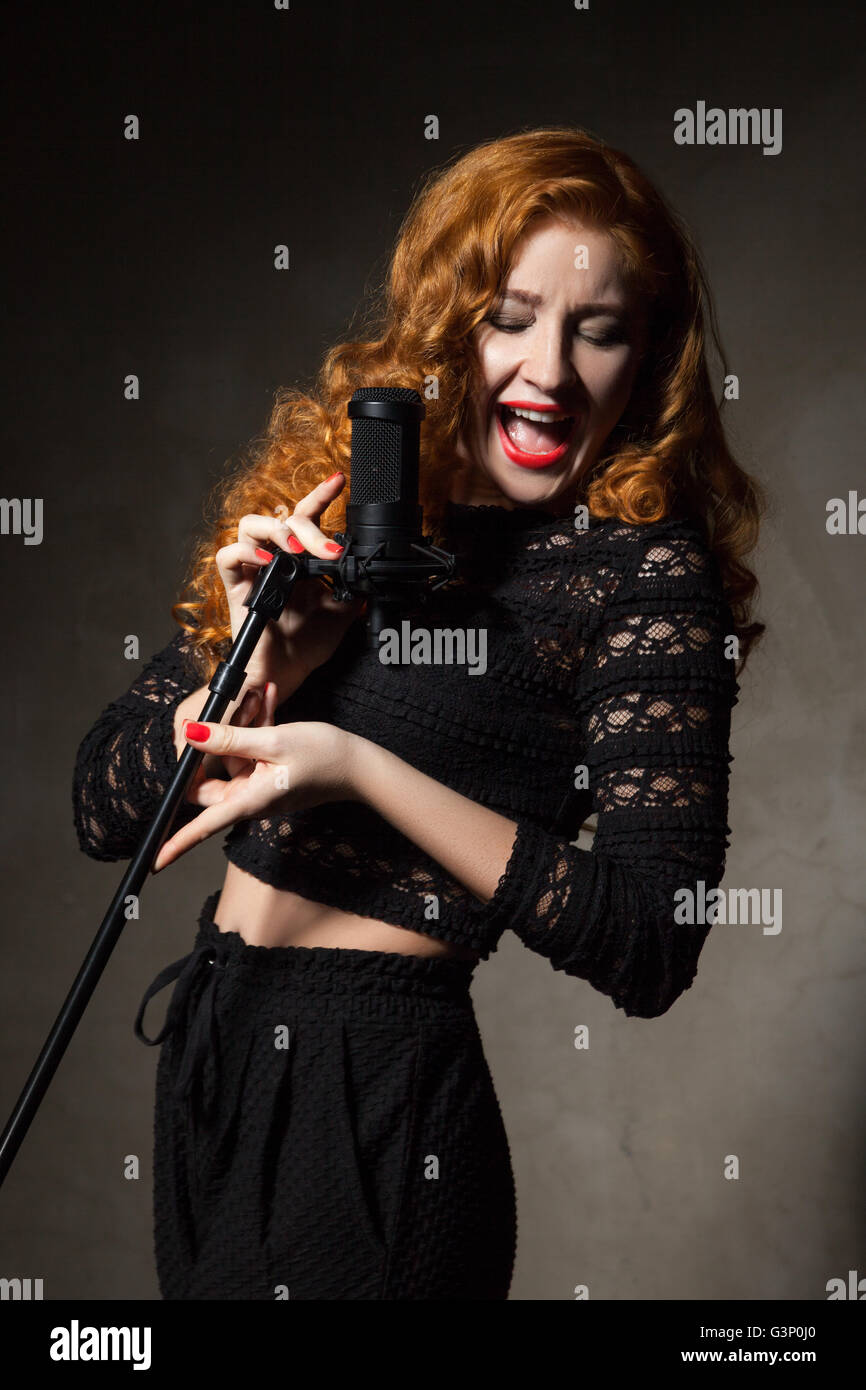 Red-haired diva singing song Stock Photo - Alamy