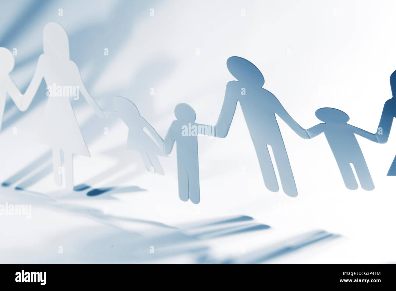 Family paper chain cutout holding hands Stock Photo - Alamy