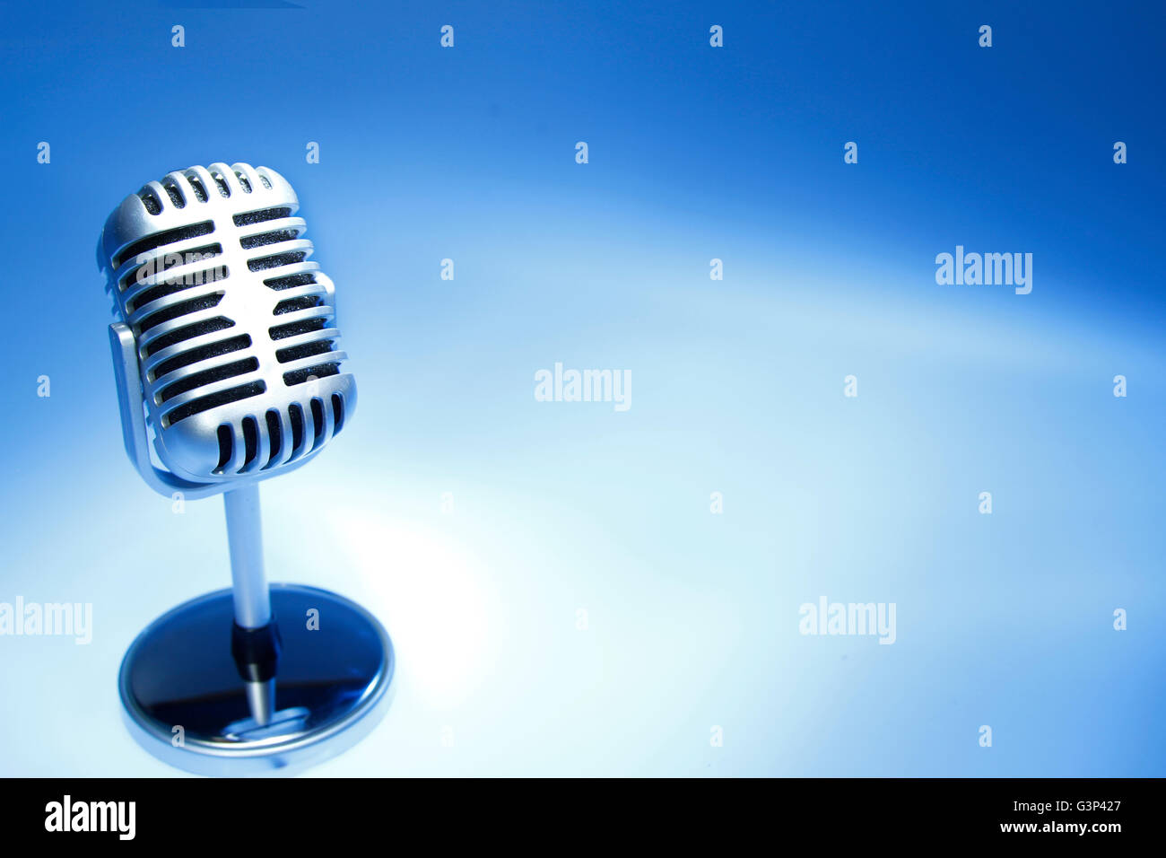Old classic microphone on blue Stock Photo - Alamy