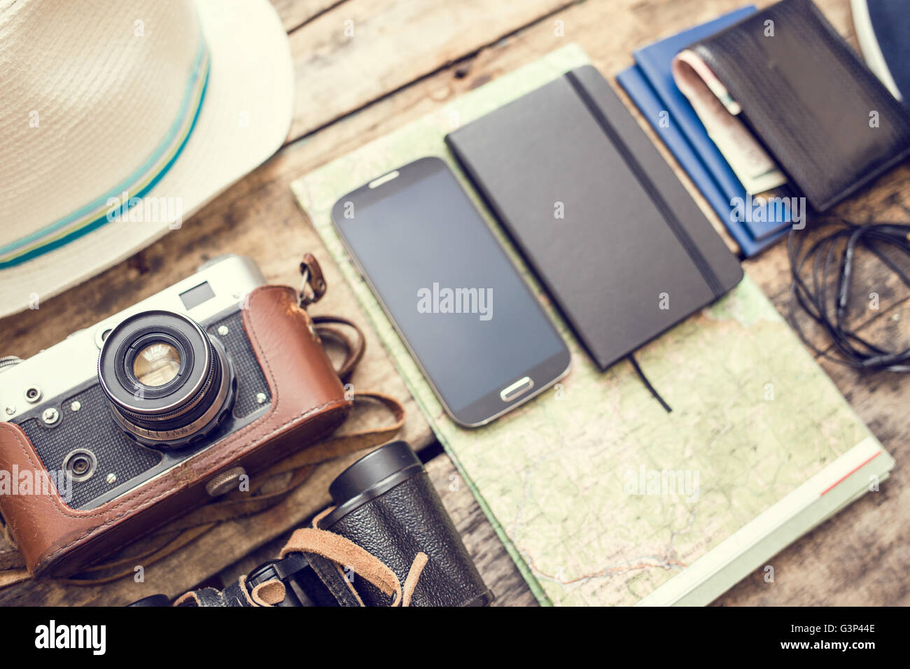 Set of accessories for travel. Shoes, camera, map, notebook on wooden ...