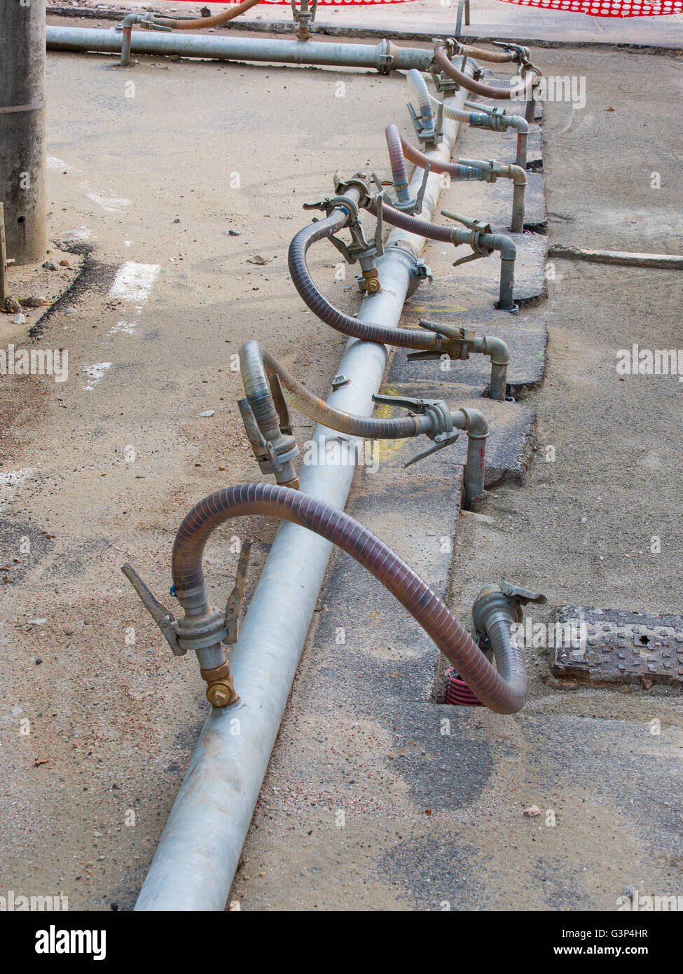 temporary metal pipes cross the road due to maintenance work Stock ...