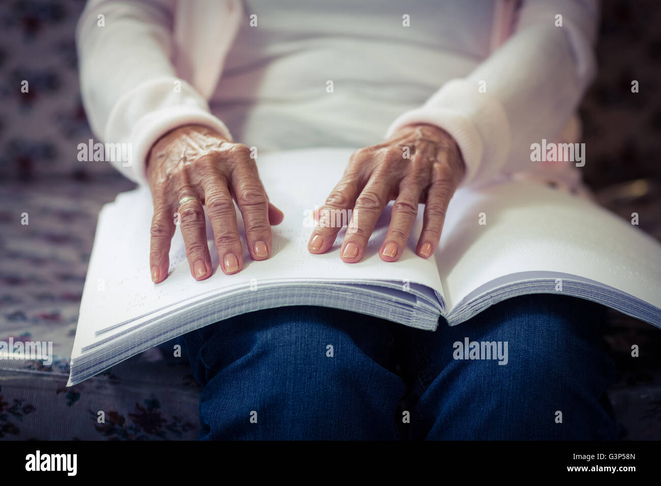 Blind woman reading a braille book Stock Photo - Alamy