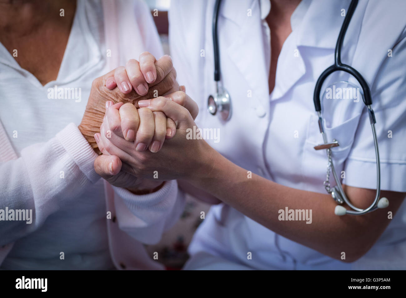 Doctor patient holding hands hi-res stock photography and images - Alamy