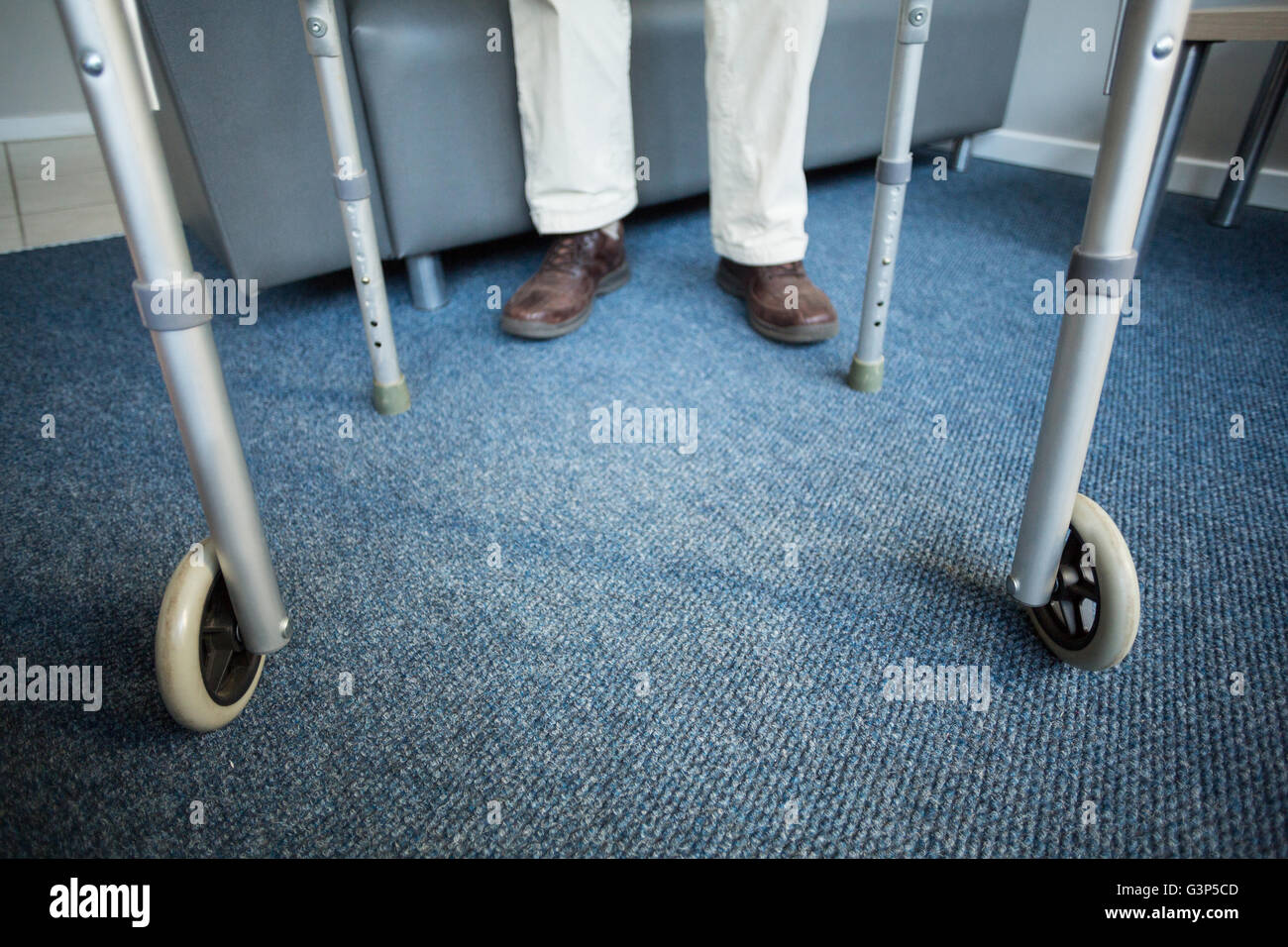 Senior man trying to stand with the help of walking frame Stock Photo ...