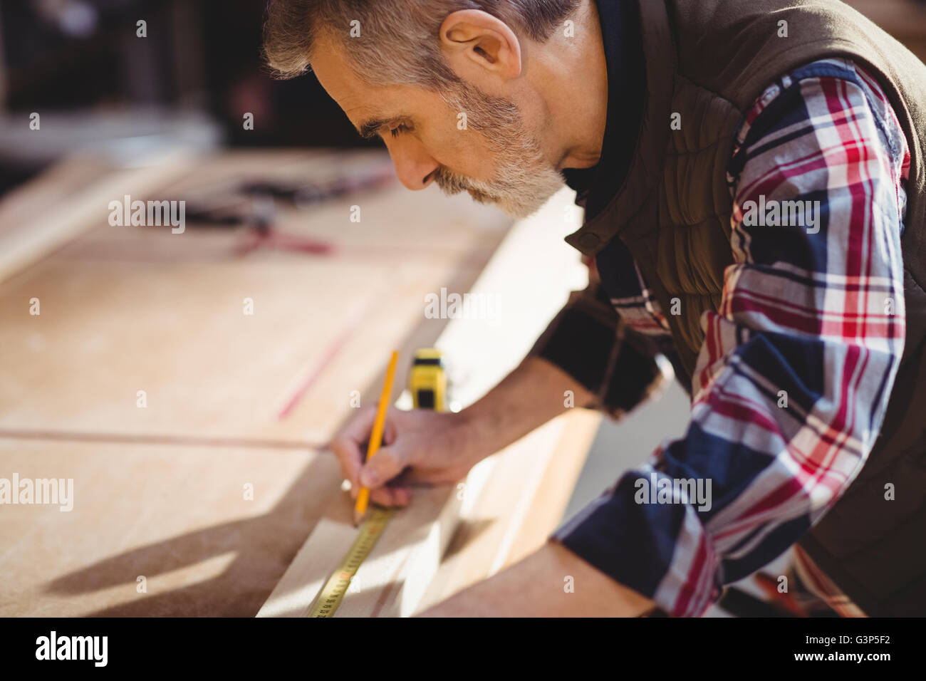 Carpenter marking on wooden plank with pencil Stock Photo - Alamy