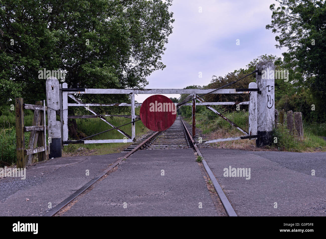 Level crossing over a disused railway line in North Norfolk, England ...