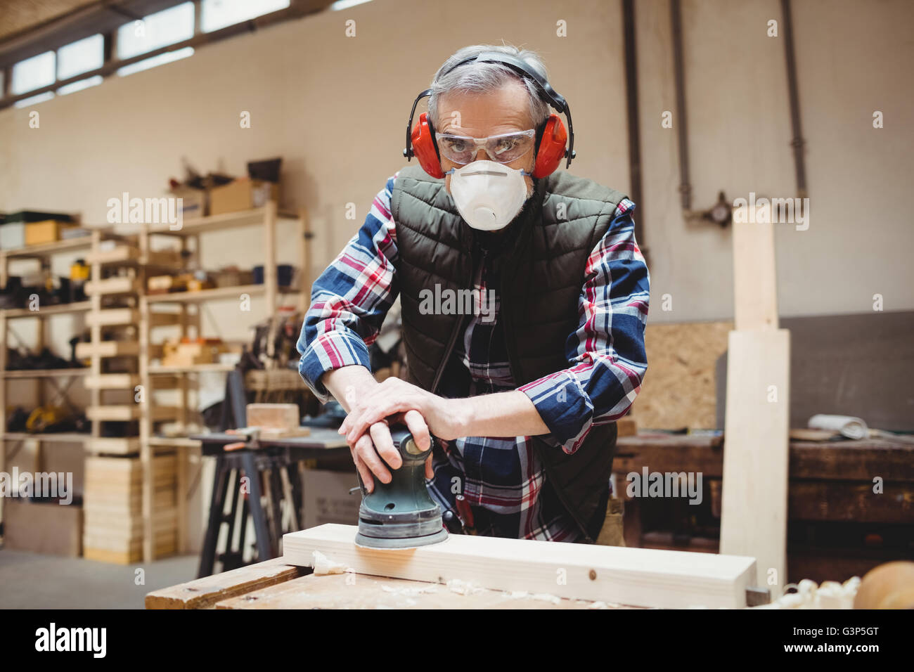 Carpenter sanding down a plank of wood Stock Photo - Alamy