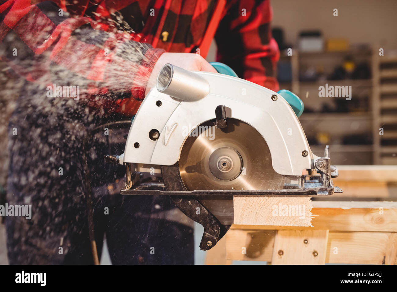 Carpenter sawing a plank of wood Stock Photo - Alamy