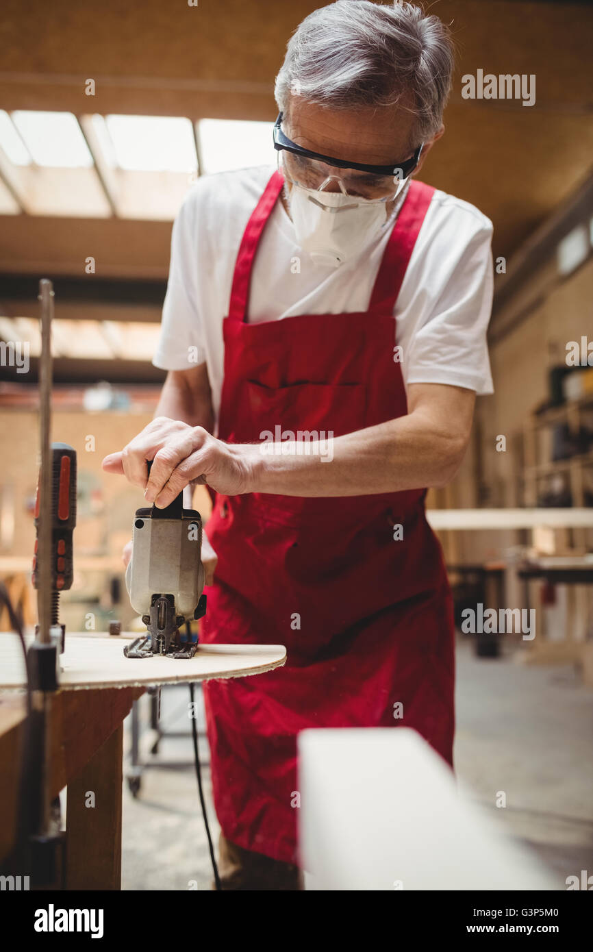 Carpenter cutting a plank of wood Stock Photo - Alamy