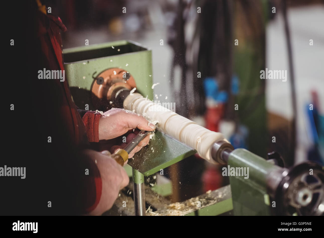 Carpenter sculpting a wood piece Stock Photo - Alamy