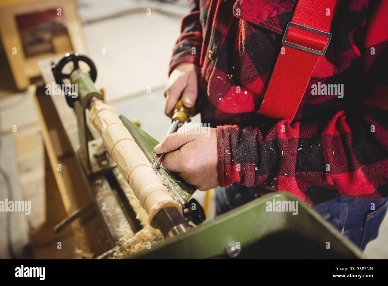 Carpenter sculpting a wood piece Stock Photo - Alamy