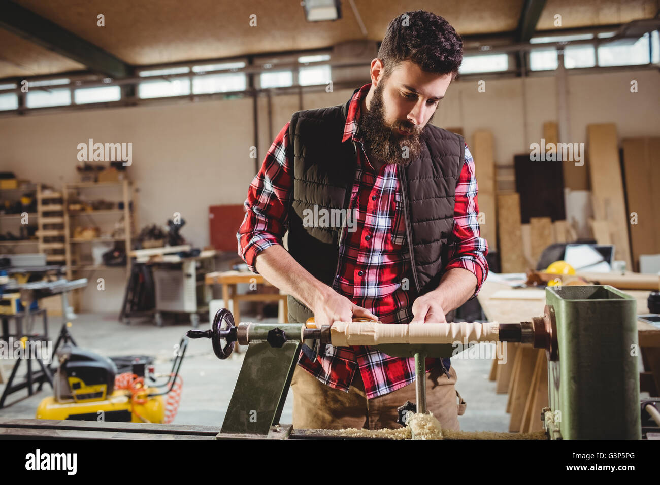 Carpenter sculpting a wood piece Stock Photo - Alamy