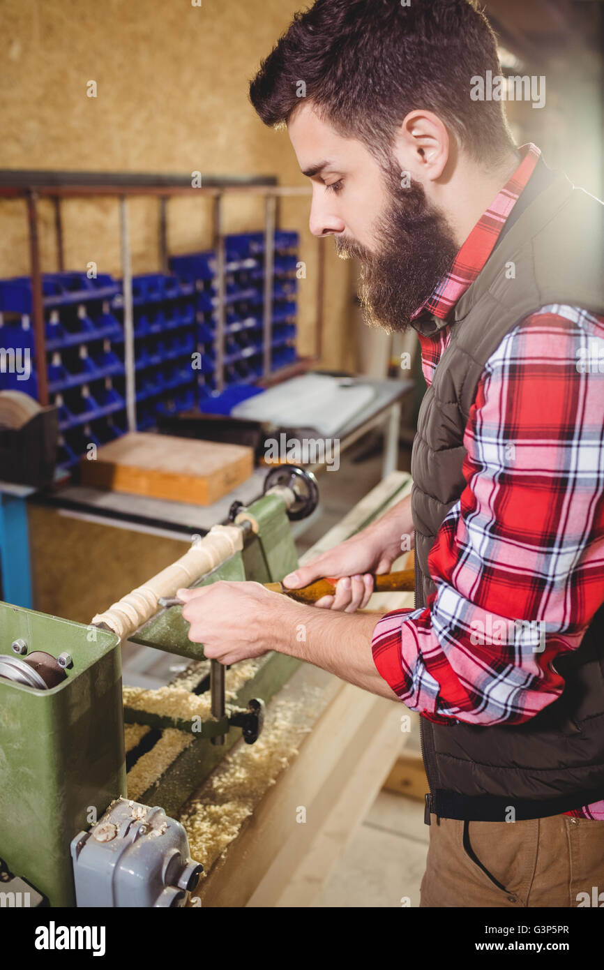 Carpenter sculpting a wood piece Stock Photo - Alamy