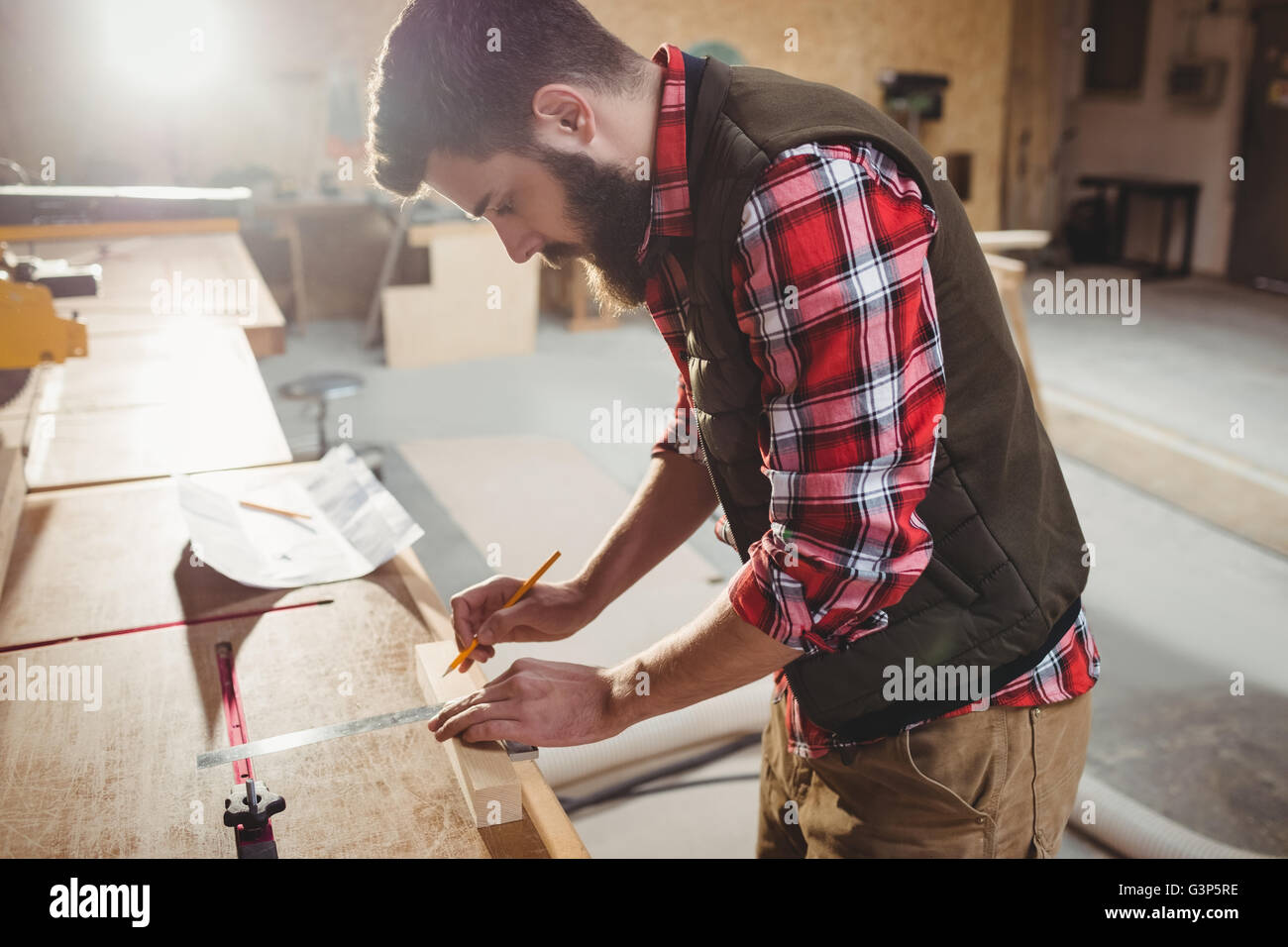 Carpenter writing a mark on a wood piece Stock Photo - Alamy