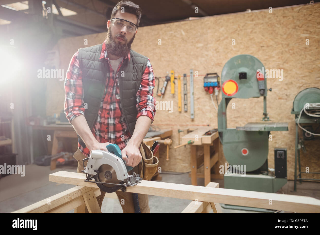 Carpenter using a machine Stock Photo - Alamy