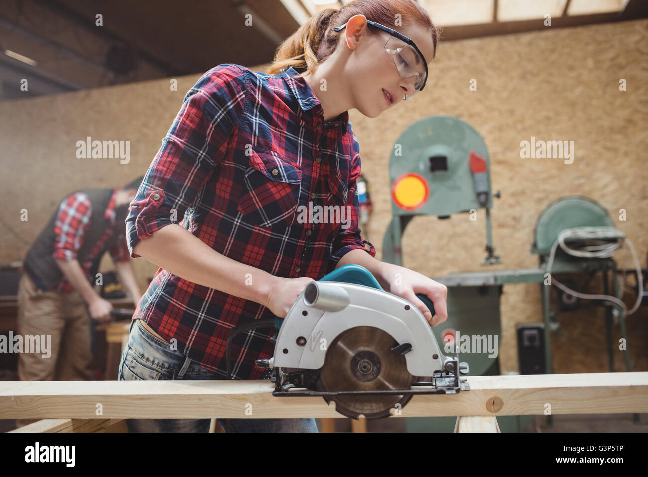 Carpenter using a machine Stock Photo - Alamy