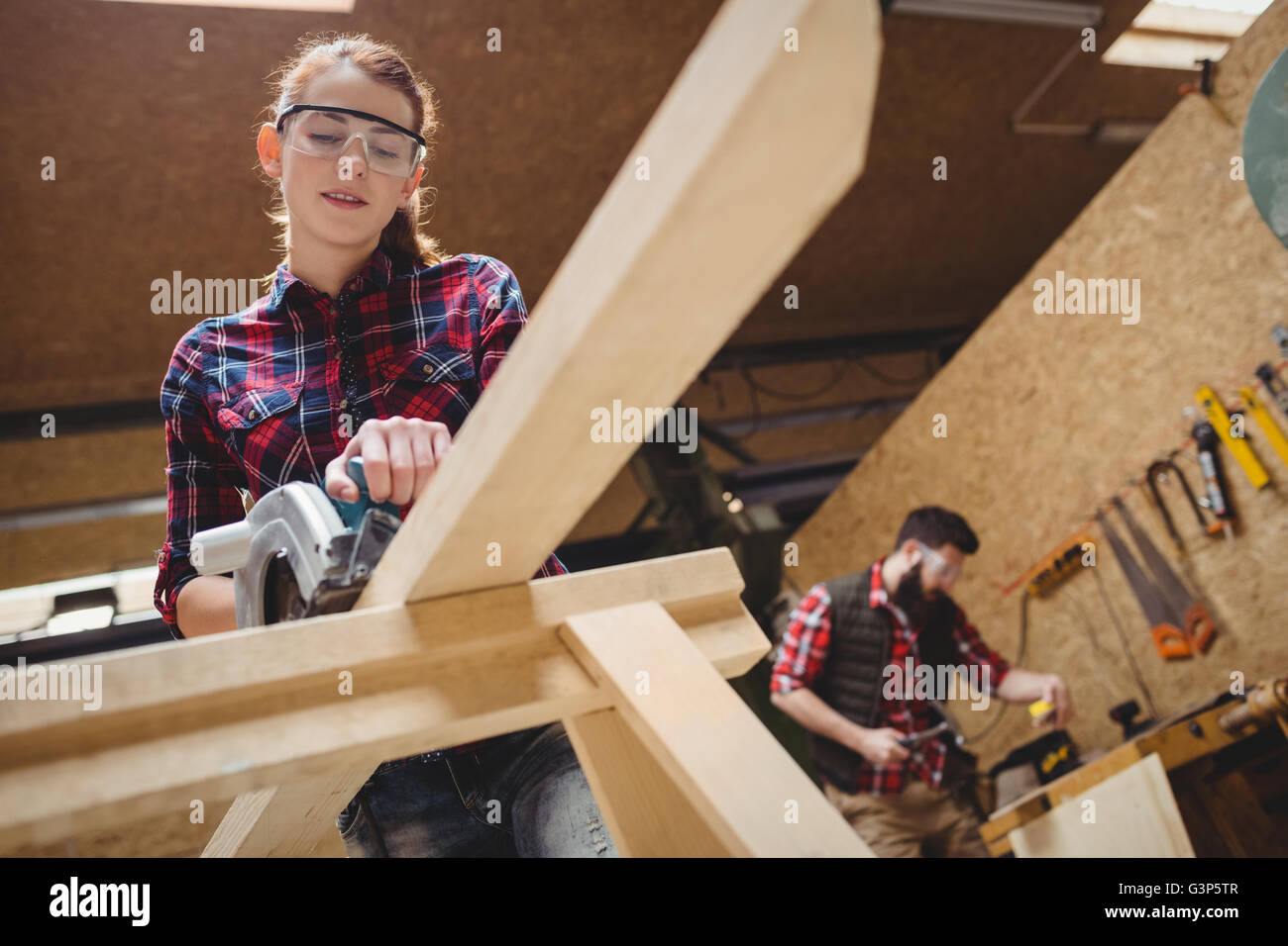 Carpenter using a machine Stock Photo - Alamy