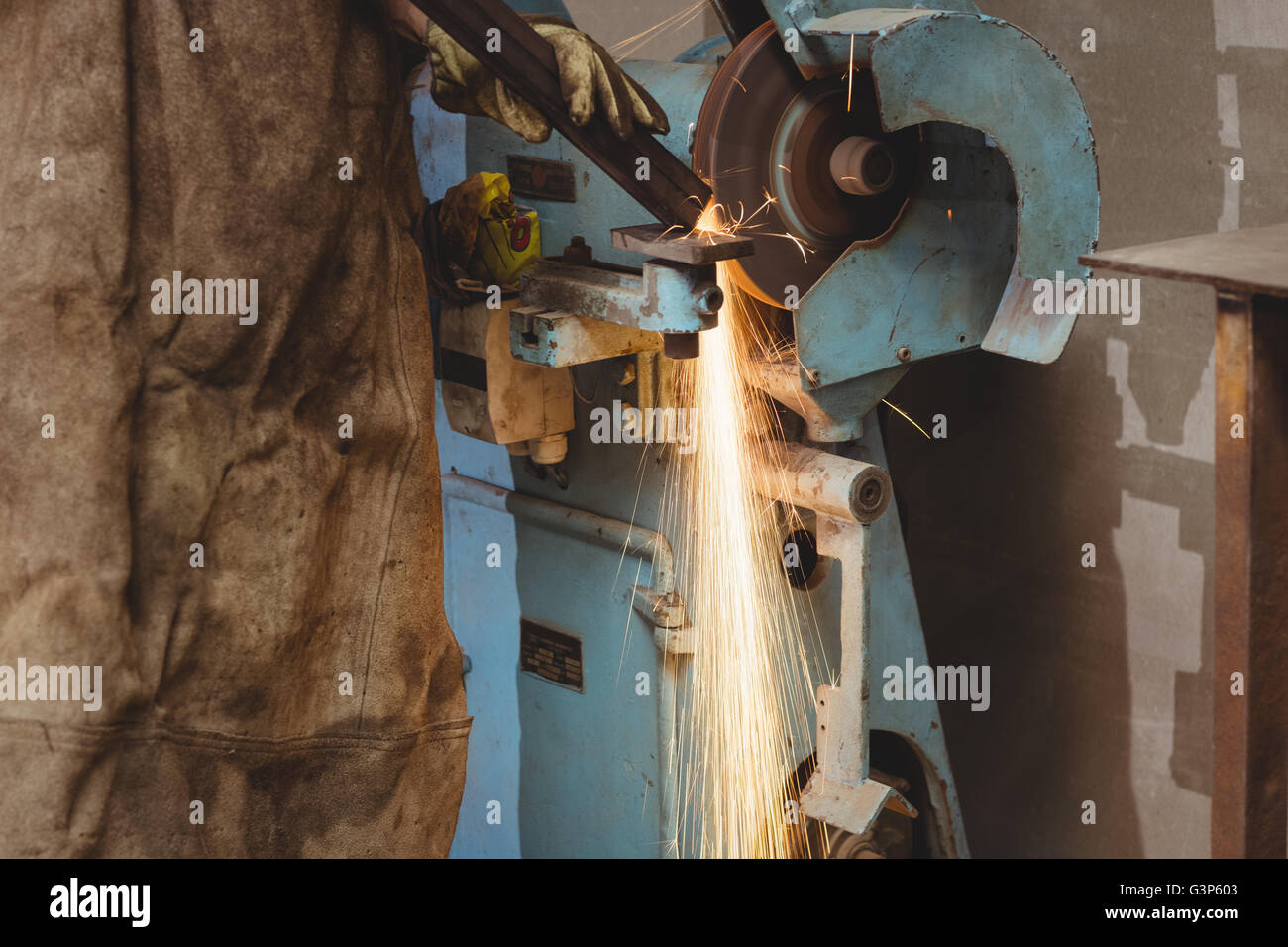 Portrait of male welder using a sander Stock Photo - Alamy