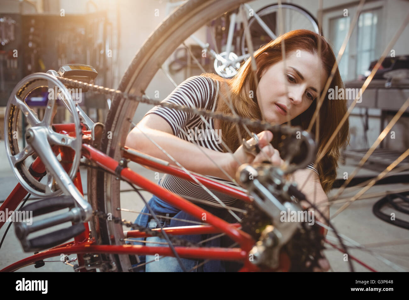 Woman repairing a bicycle Stock Photo - Alamy