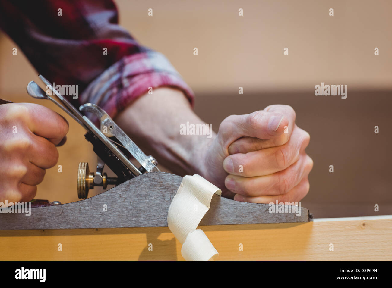 Portrait of carpenter perfecting wood plank form with a work tool Stock ...