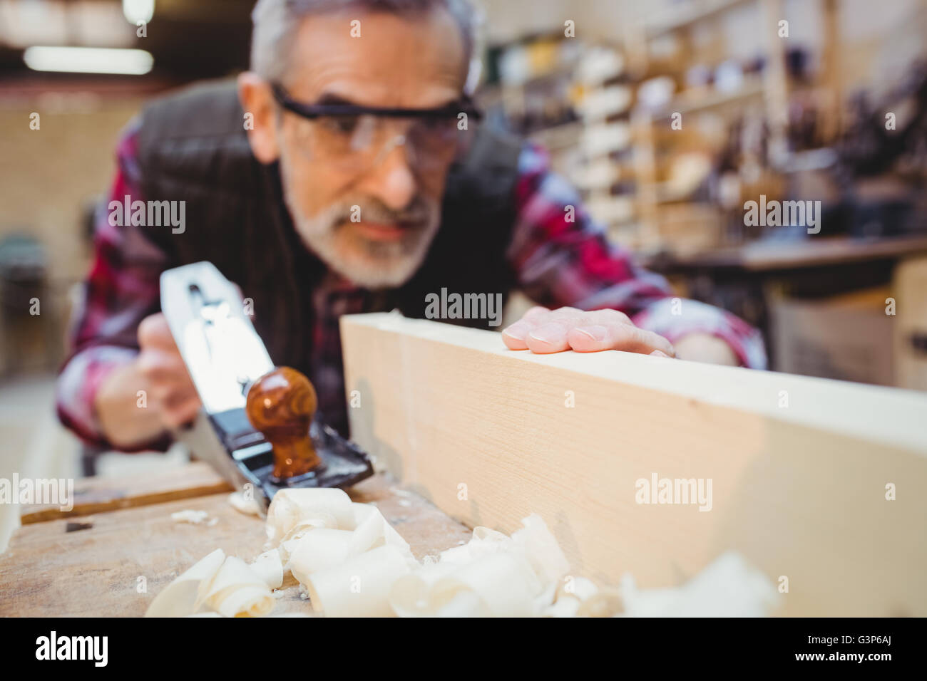 Carpenter using a sander to make smoother a wood plank Stock Photo - Alamy