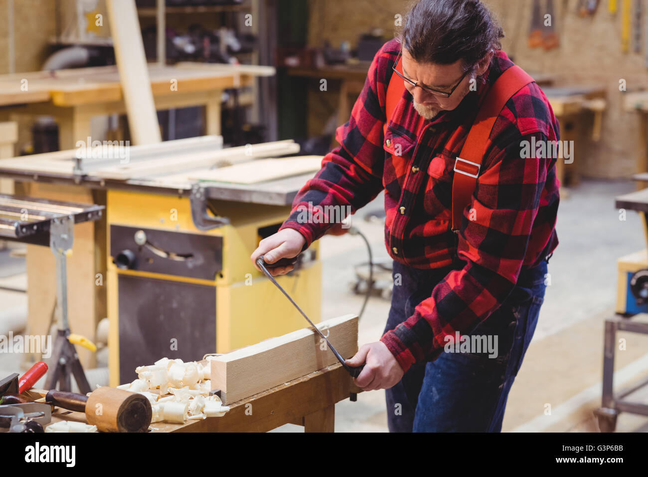 Carpenter measuring a wood plank Stock Photo - Alamy