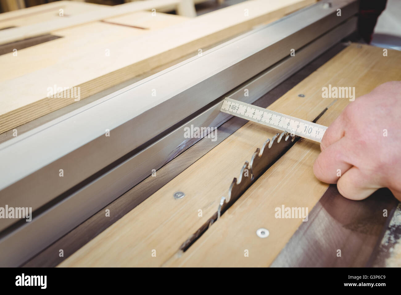 Carpenter measuring wood plank Stock Photo - Alamy