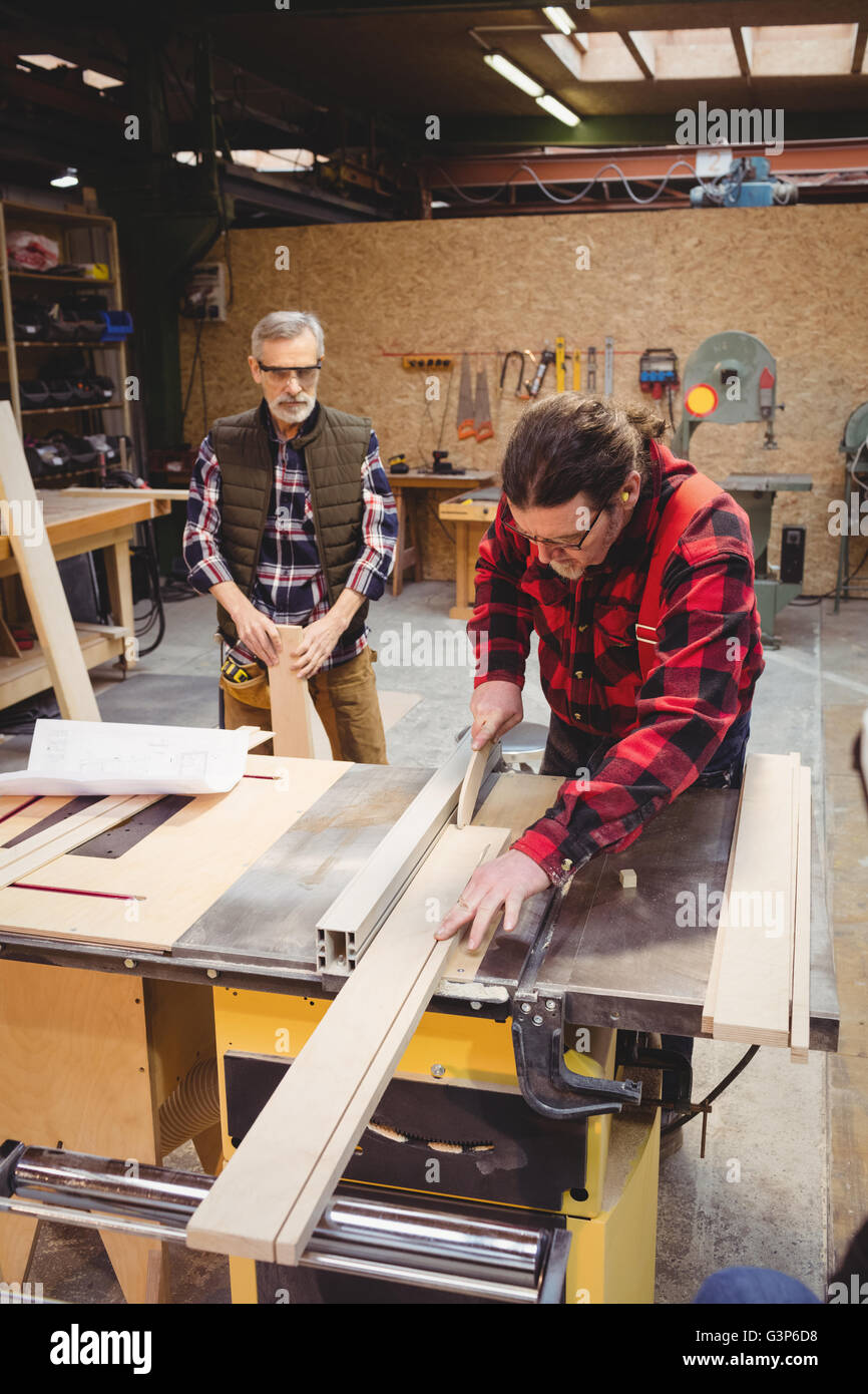 Duo of carpenter working in their workshop Stock Photo - Alamy