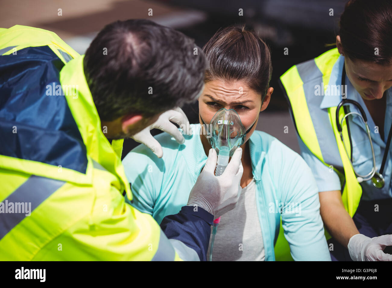 Portrait of a jogger taking in hand by ambulance crew Stock Photo - Alamy