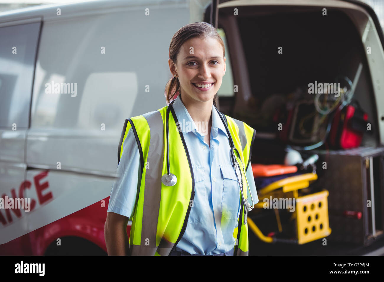 Portrait of smiling ambulance woman Stock Photo - Alamy
