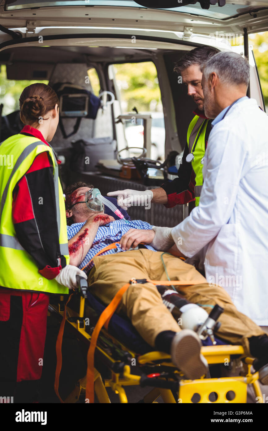 Ambulance crew and doctor taking care of an injured person Stock Photo ...